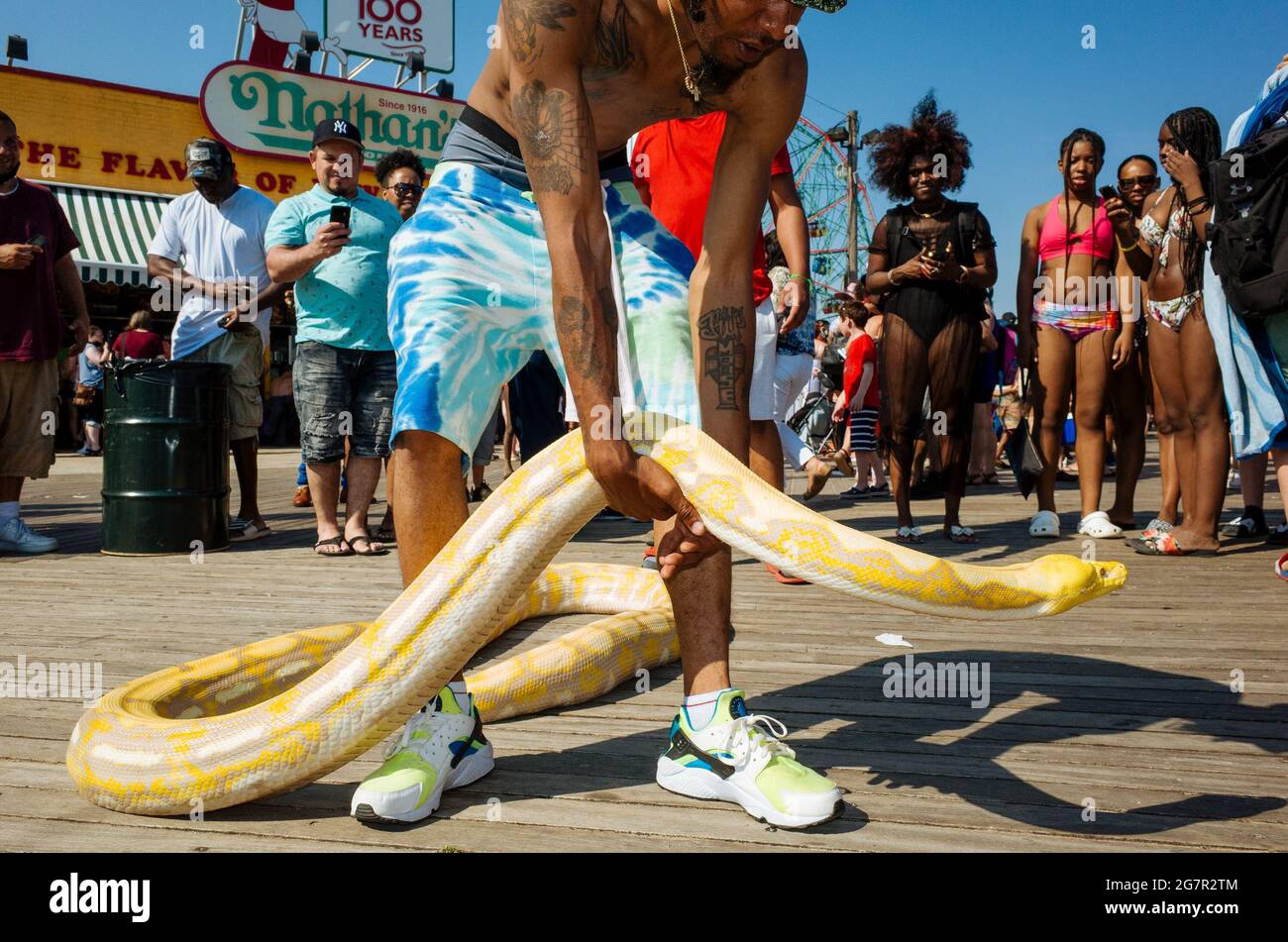 New York, USA. 06th June, 2021. Onlookers watch a man holding a large ...