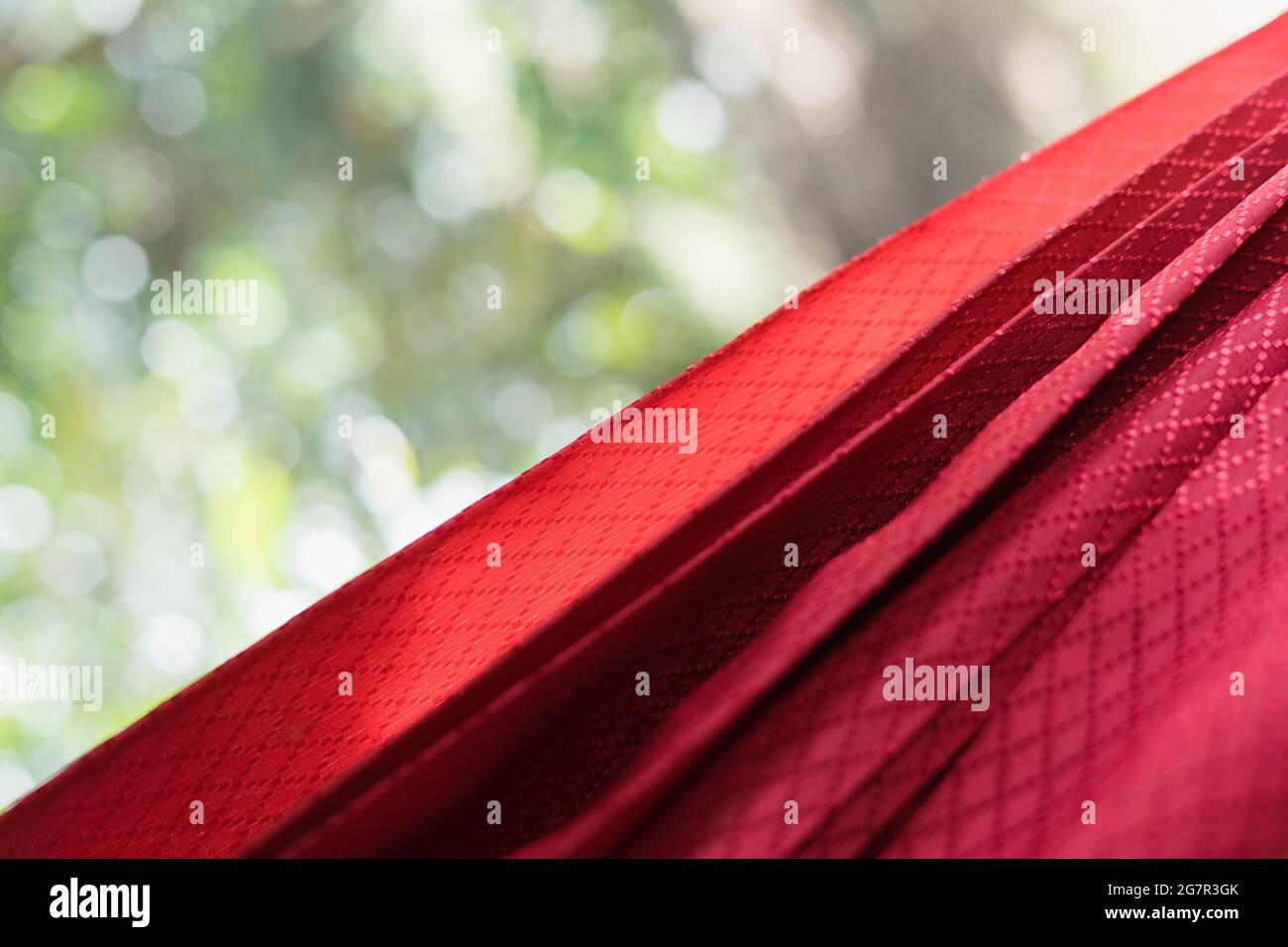 Shallow depth of field of a folded red curtain with wooden frame on a ...