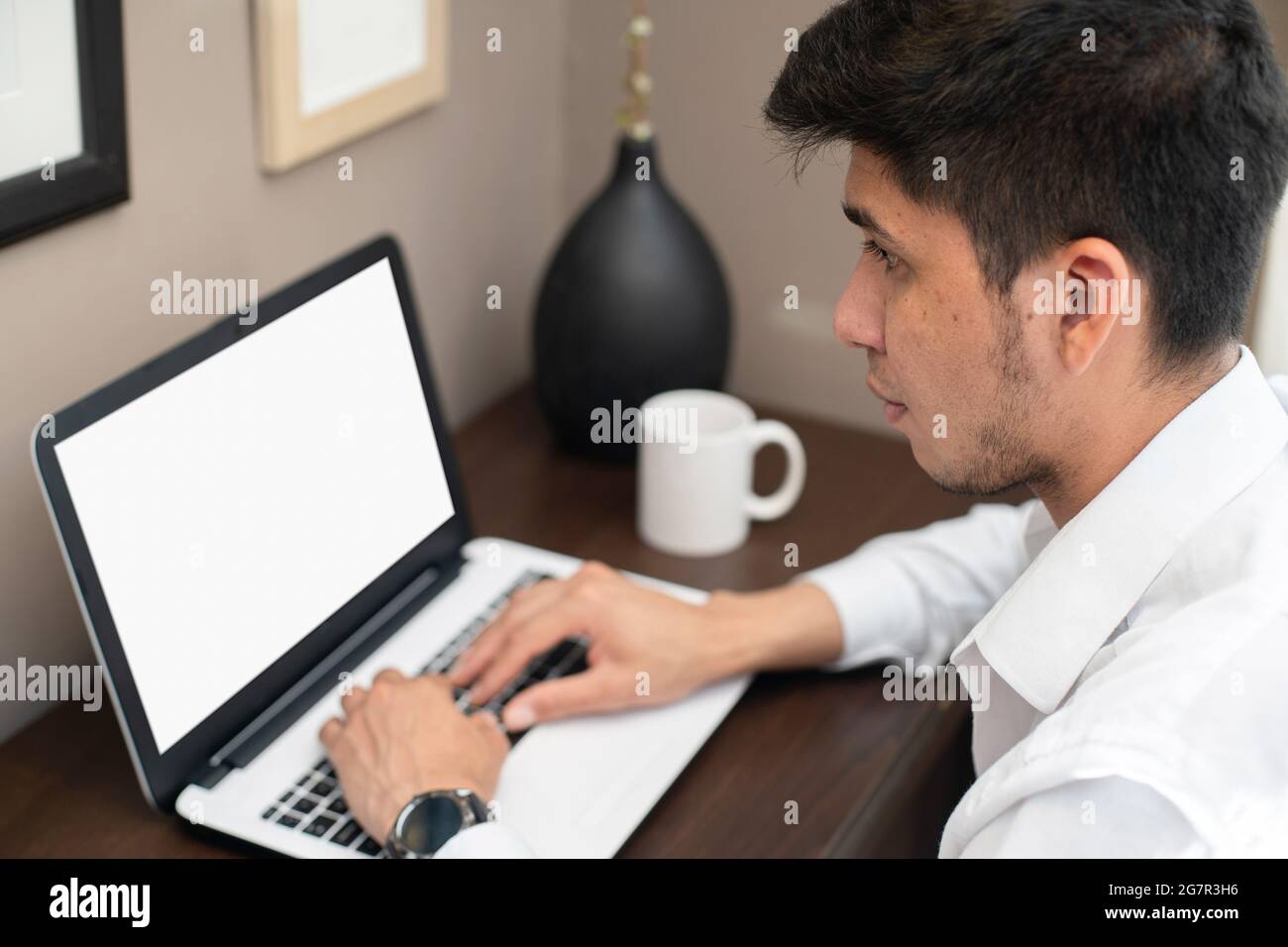 Closeup shot of a Latino man working at home with his laptop Stock ...