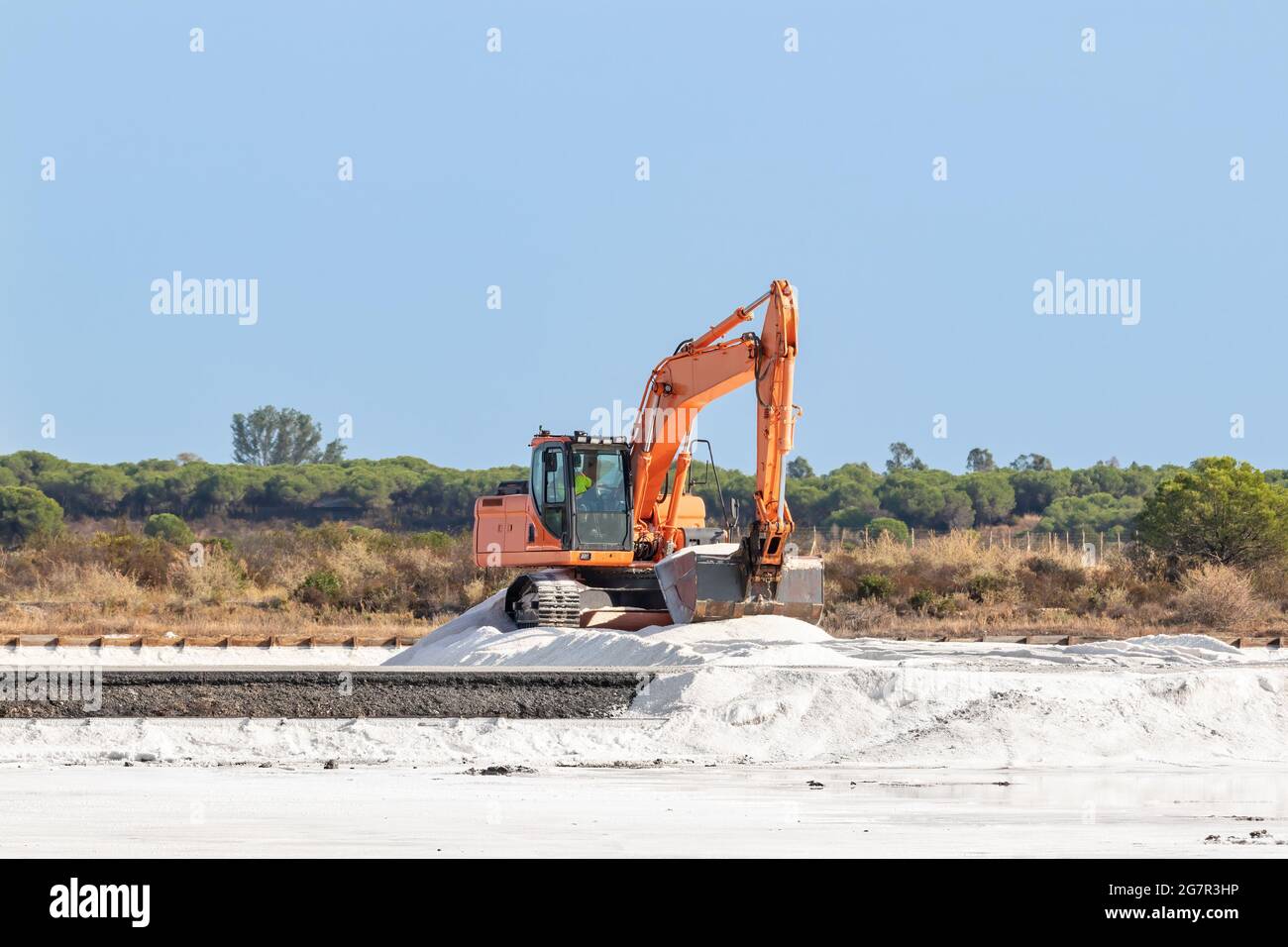 Excavator working in salt production in nature reserve Marismas del ...