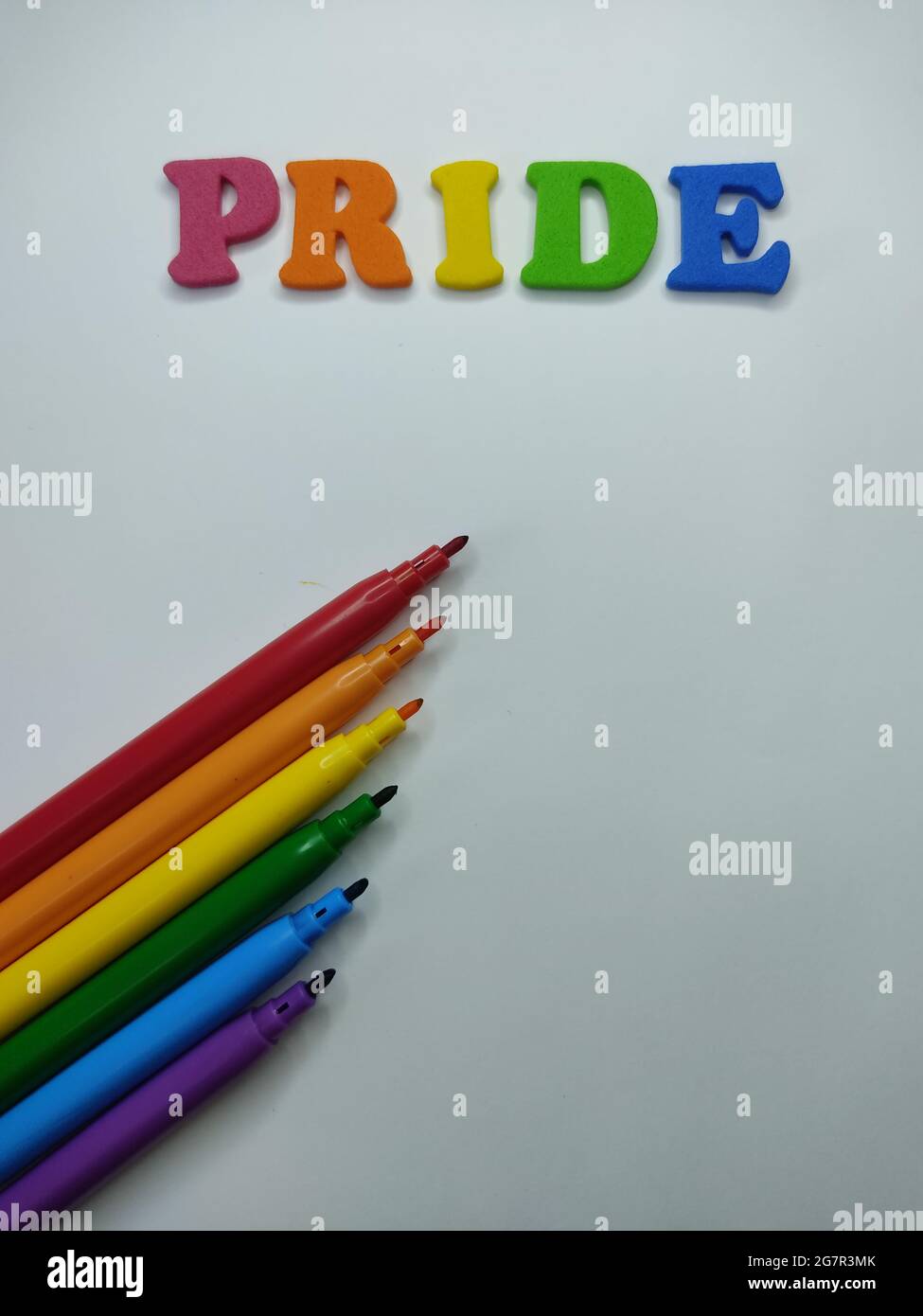 Vertical text PRIDE next to markers of pride colors isolated on white ...