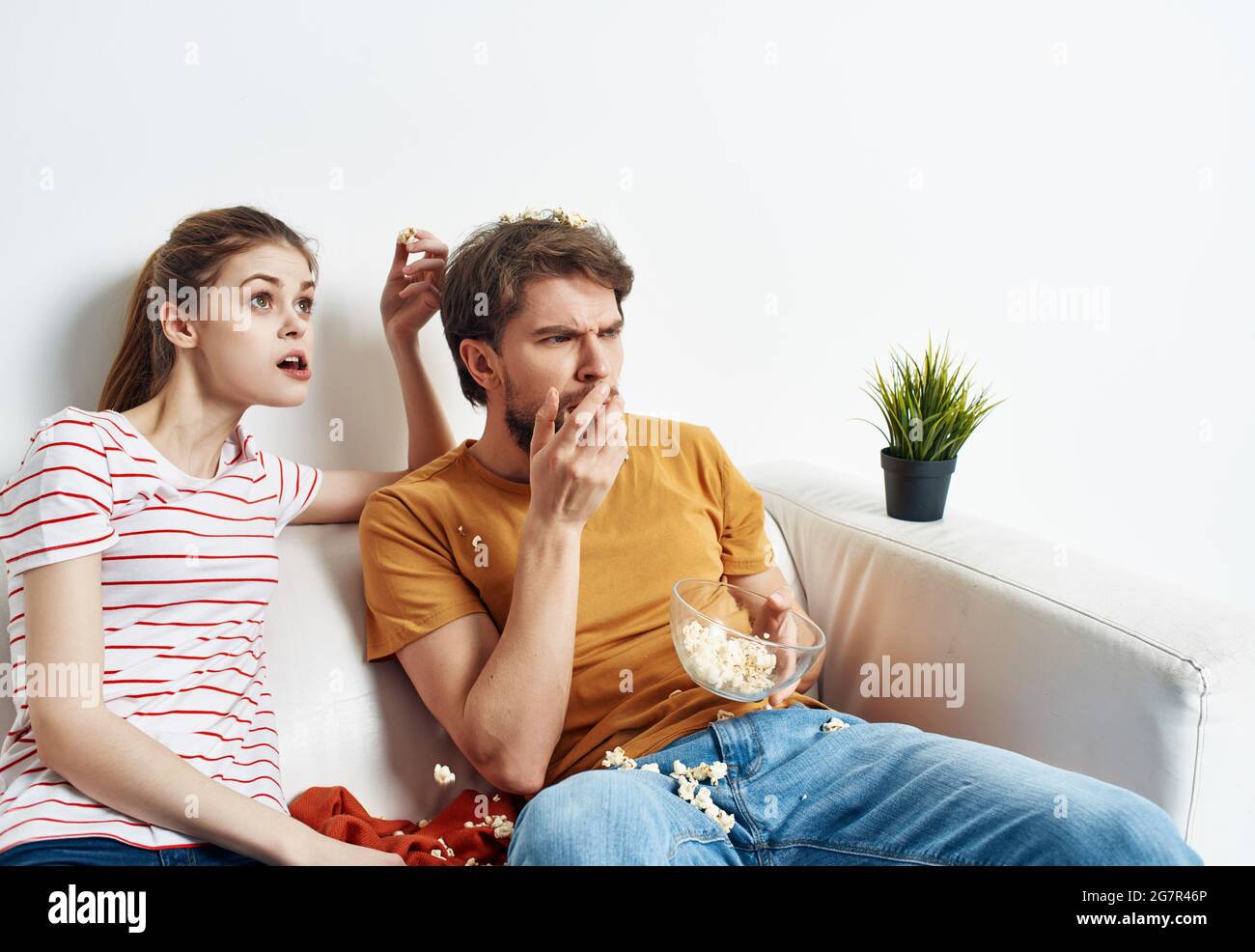 man and woman at home on the couch watching tv popcorn entertainment ...