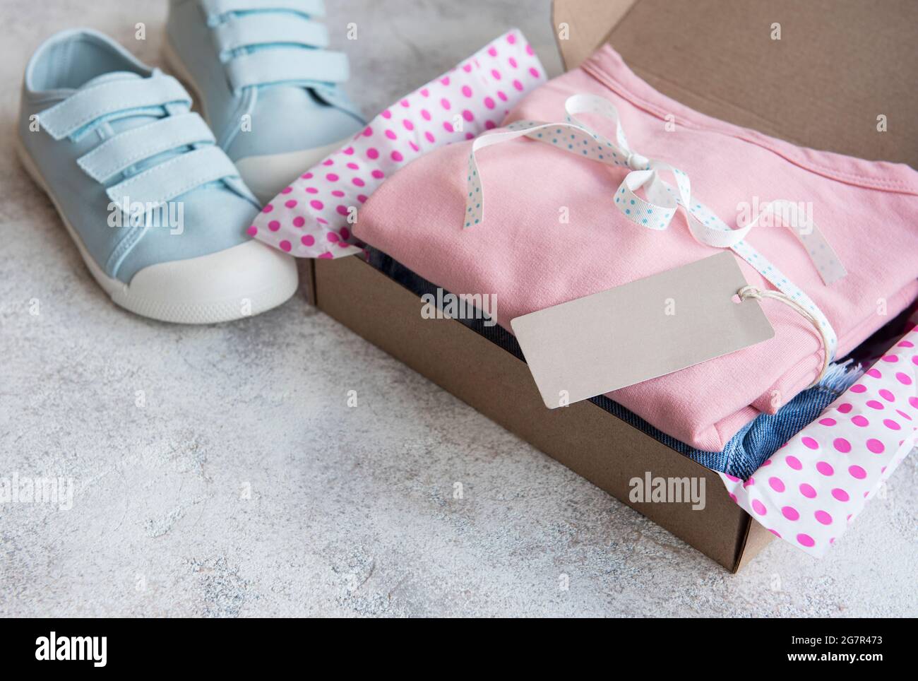 Clothes for kids in an open cardboard box. Online shopping concept ...