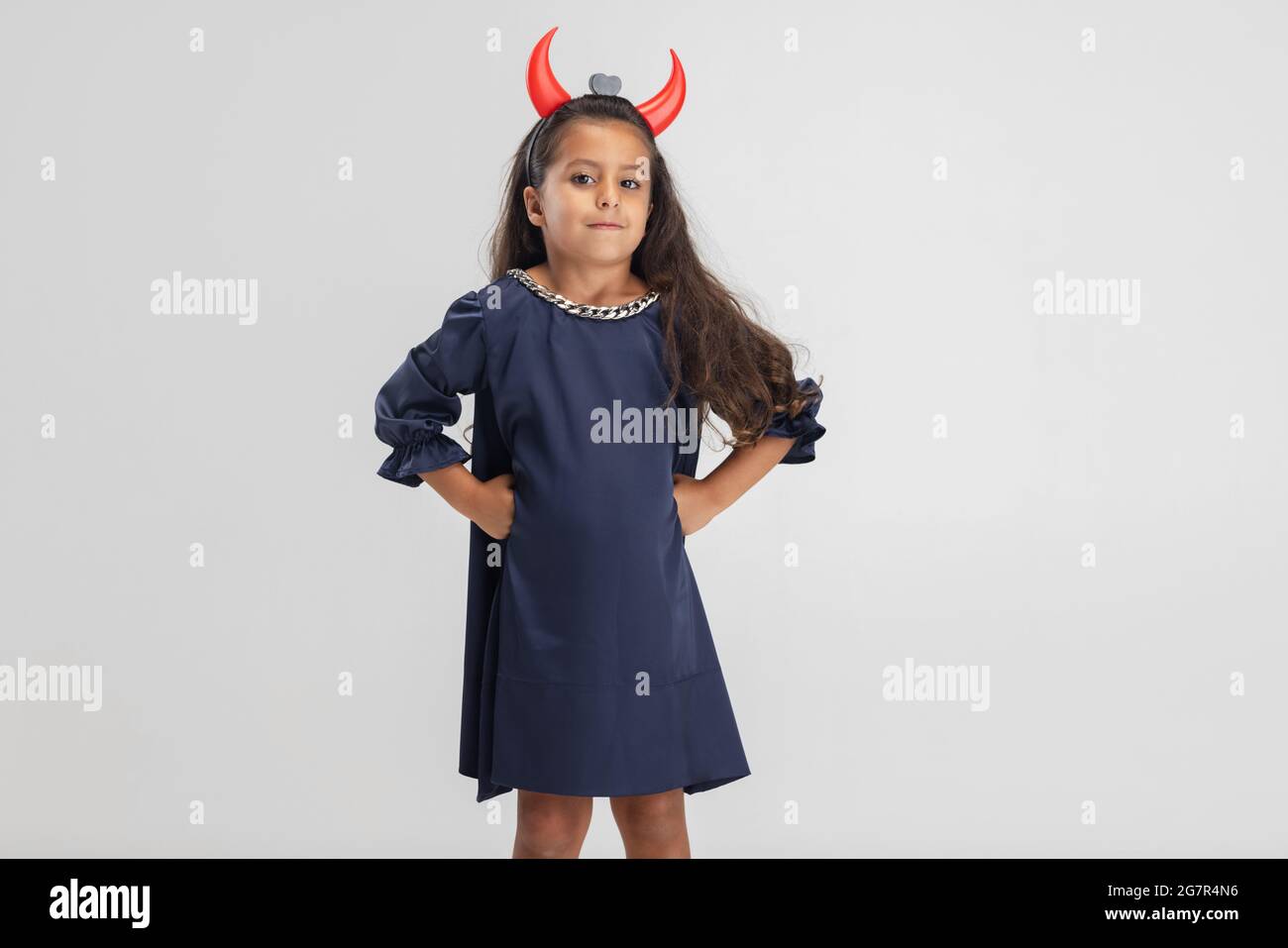 Half-length portrait of one cute Caucasian preschool girl with red toy ...