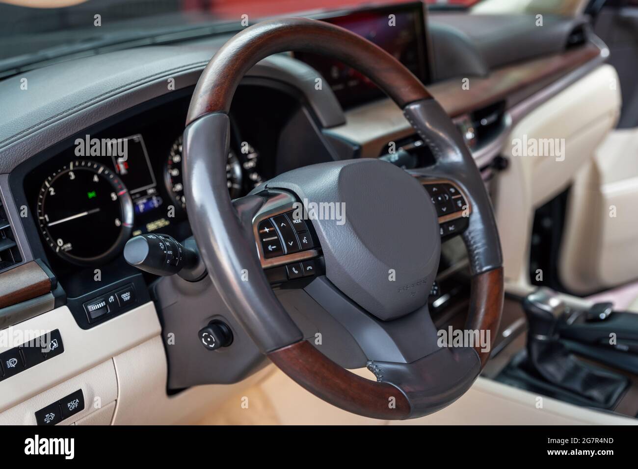 Car dashboard and steering wheel with media control buttons. Beige ...