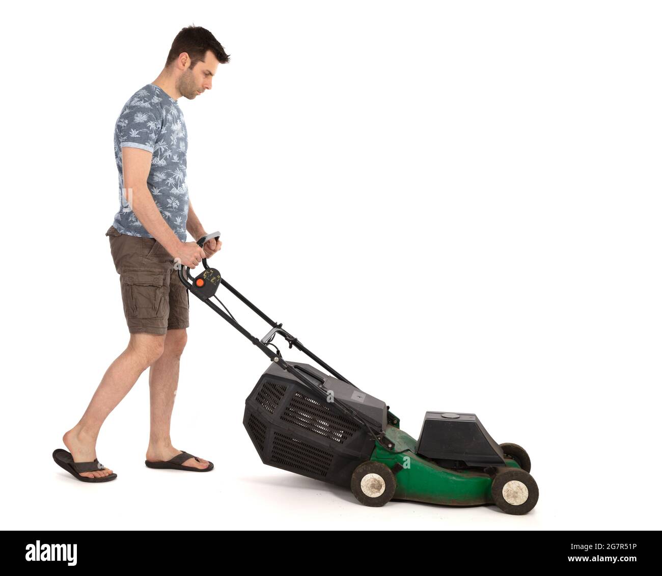 Man pushing old green lawn mower - Isolated on white background Stock ...