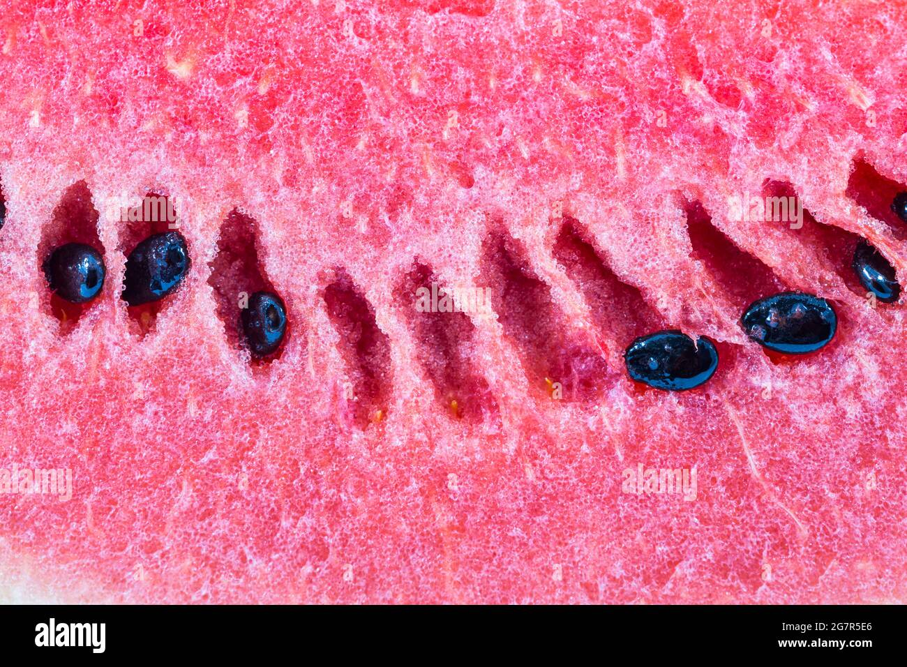 Red watermelon flesh and black seeds on white background Stock Photo ...