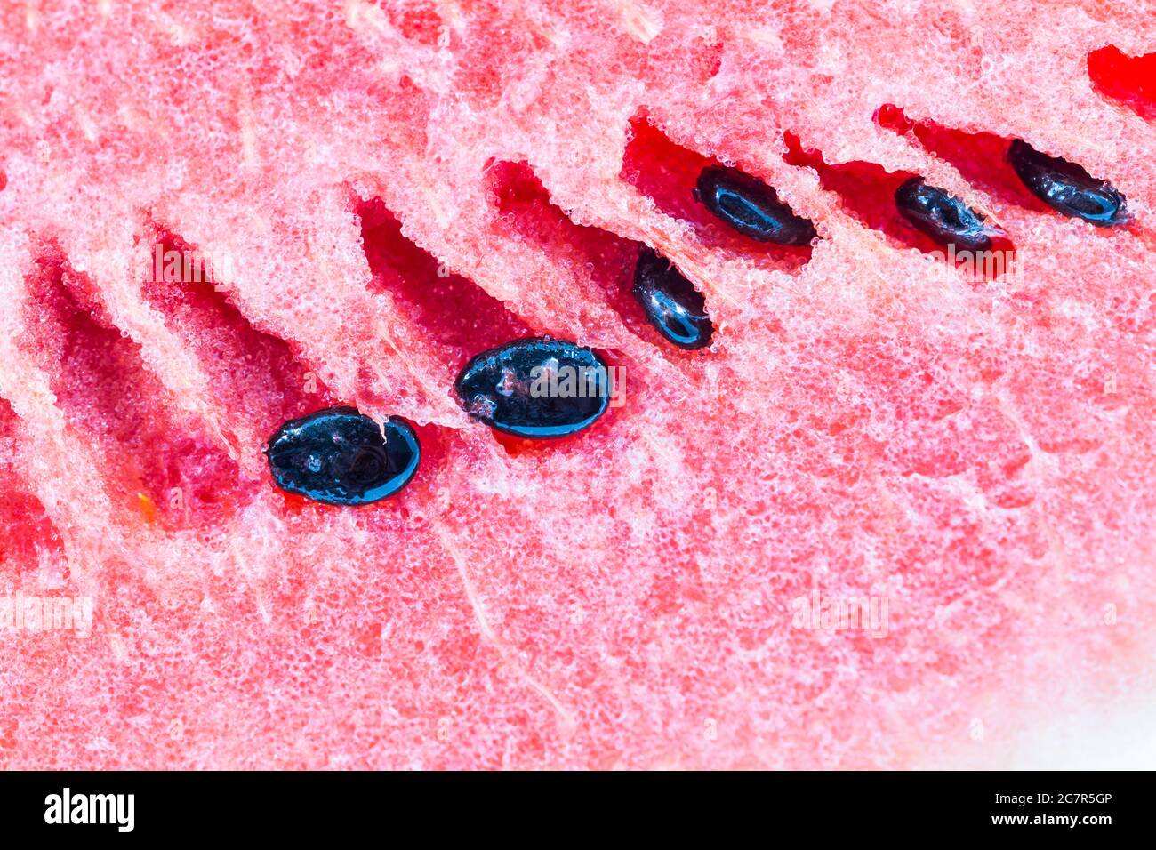 Red watermelon flesh and black seeds on white background Stock Photo ...