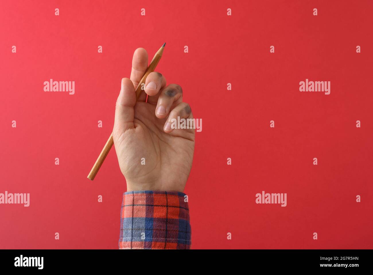 Dirty left hand in red shirt after writing. Left hander day concept ...