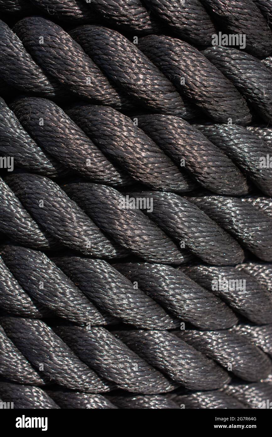Vertical shot of black rope Stock Photo - Alamy