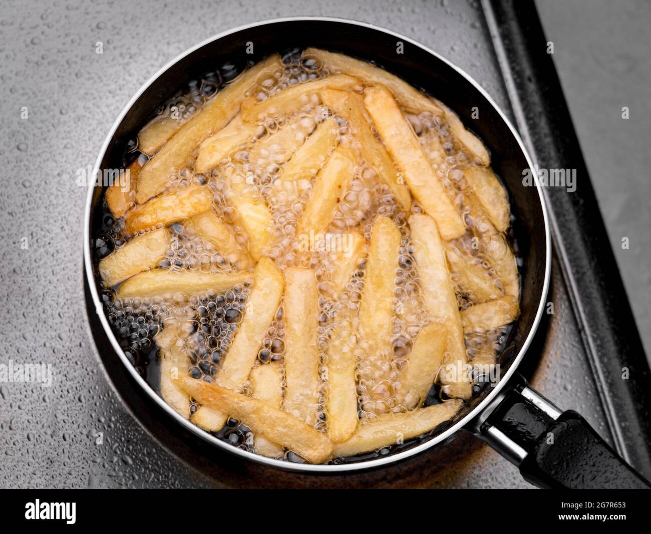 Close up of Frying french fries in the fryer in hot oil on the electric ...
