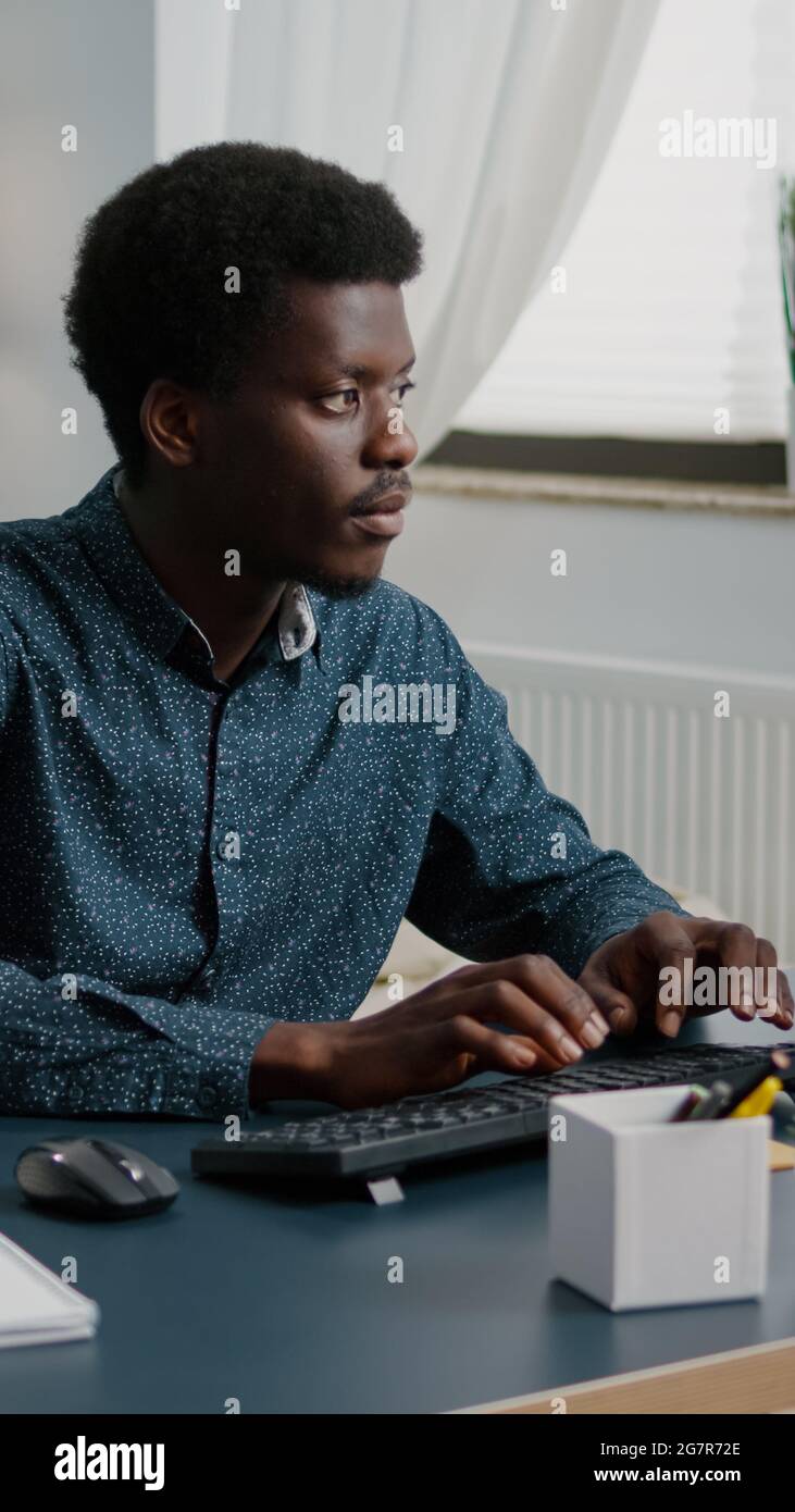 Authentic black man computer user working from home in cozy flat ...