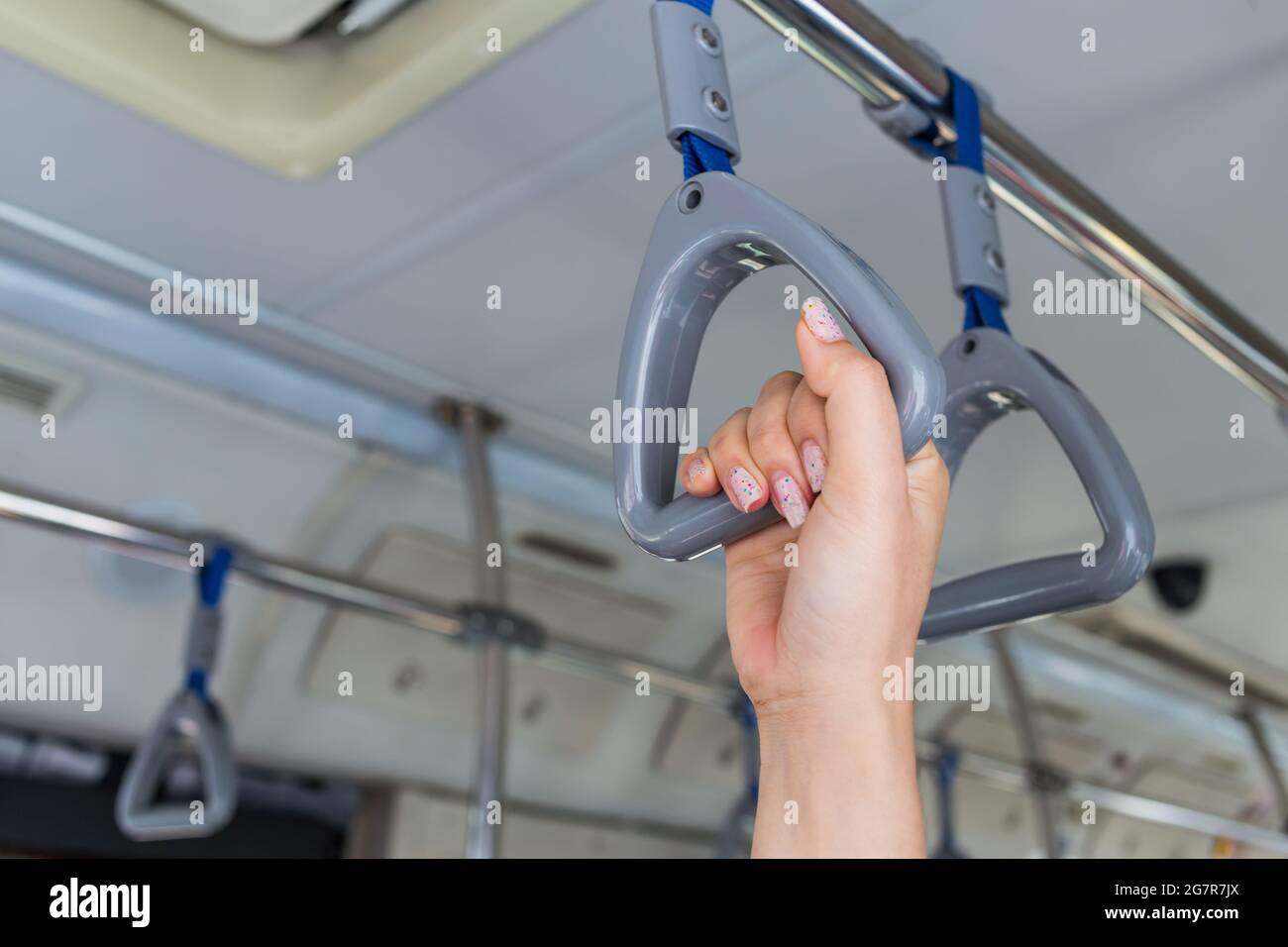 Women hand handle loop in the subway Stock Photo - Alamy
