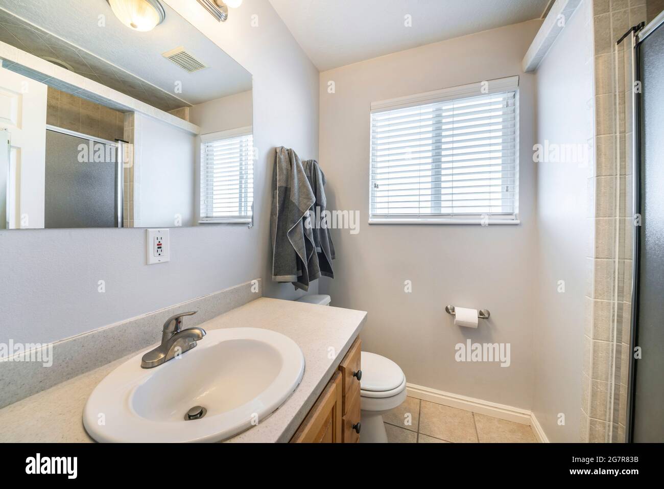 Bathroom interior with window and vanity sink unit Stock Photo - Alamy