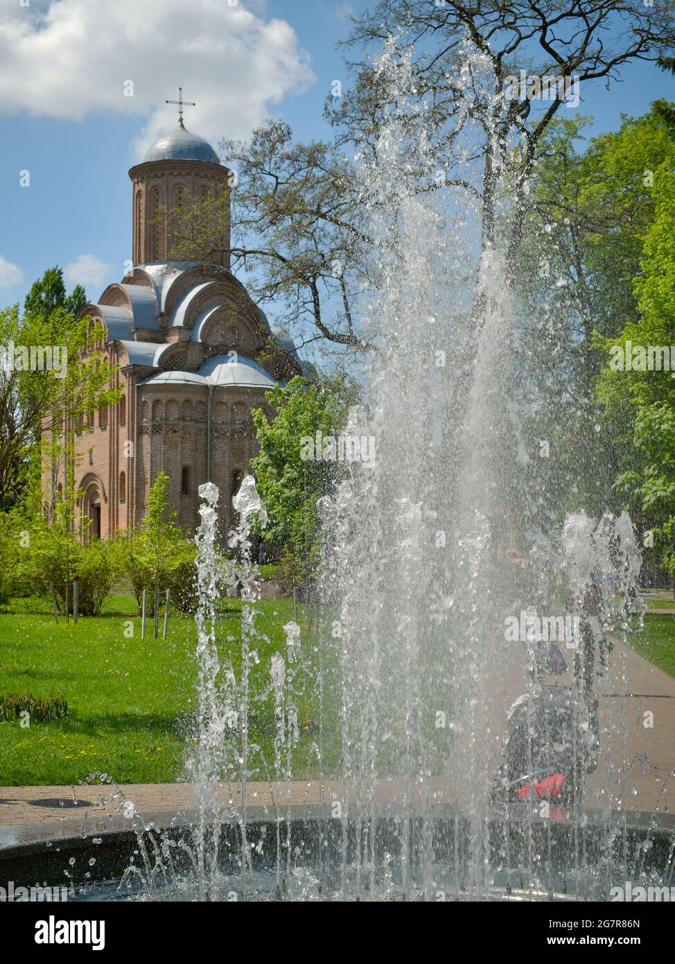Water fountain and ancient church in springtime Stock Photo - Alamy