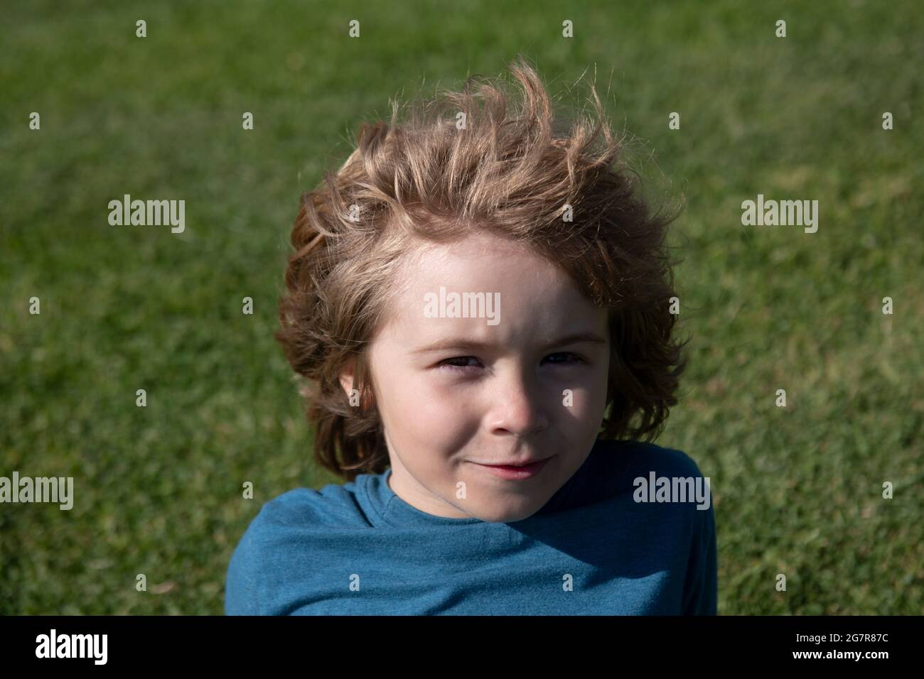 Funny child face close up. Kids on grass in park head portrait Stock ...