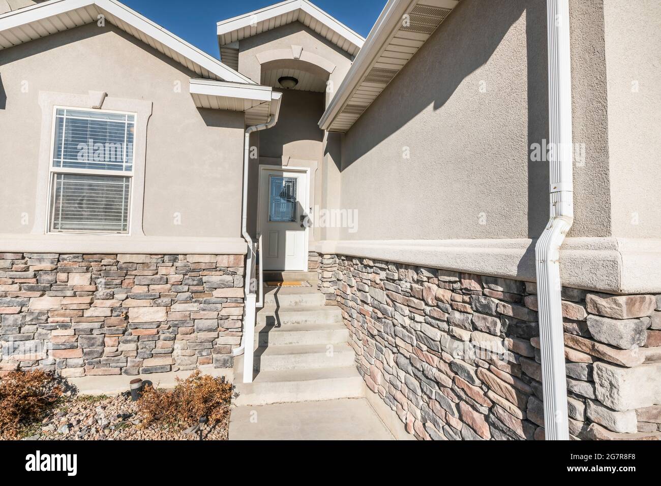 Exterior of a concrete bungalow house with stone bricks siding Stock ...