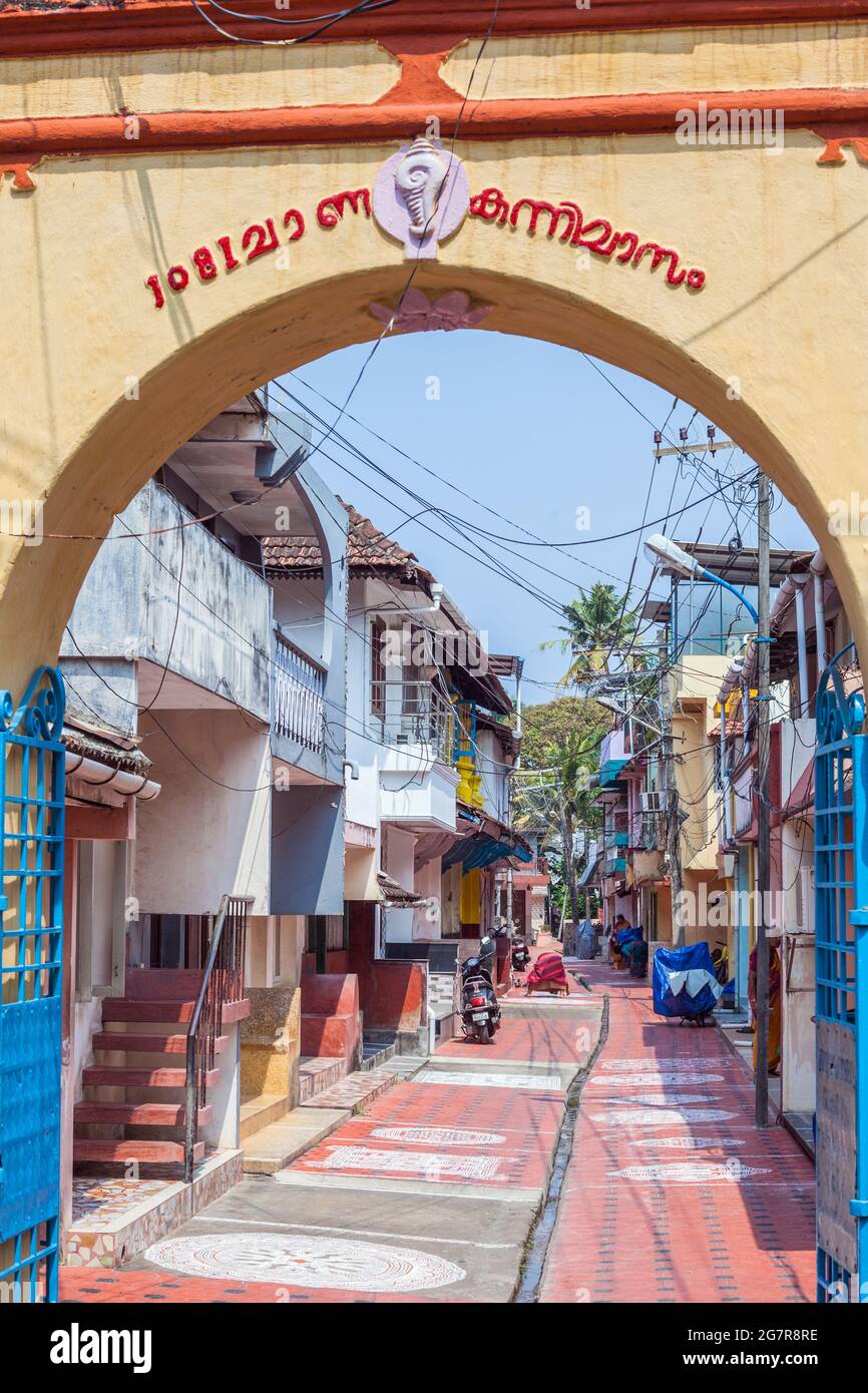 Gated archway entrance to housing complex with kolam designs outside ...