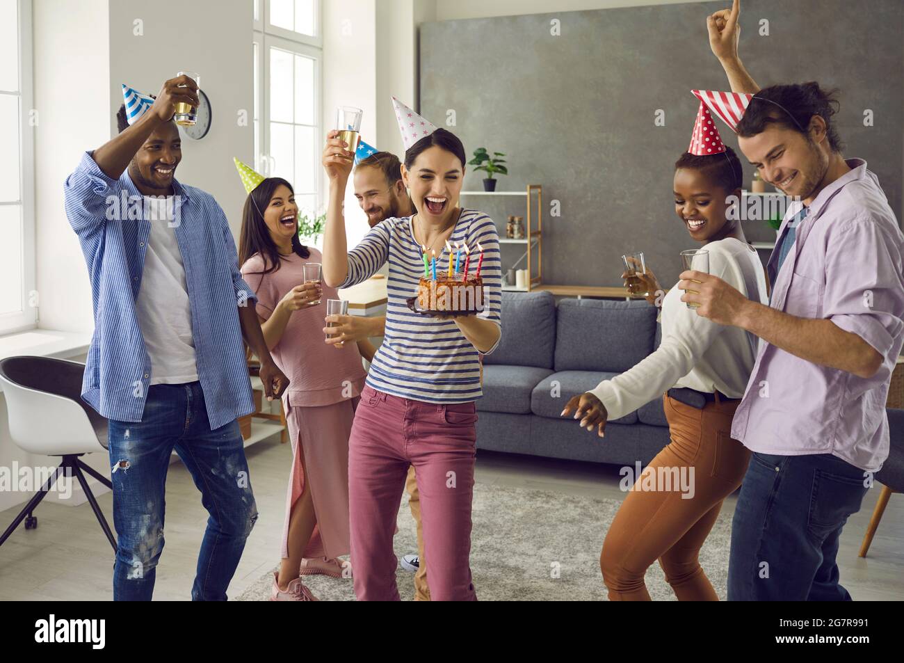 Diverse group of happy people dancing and having fun at their friend's ...