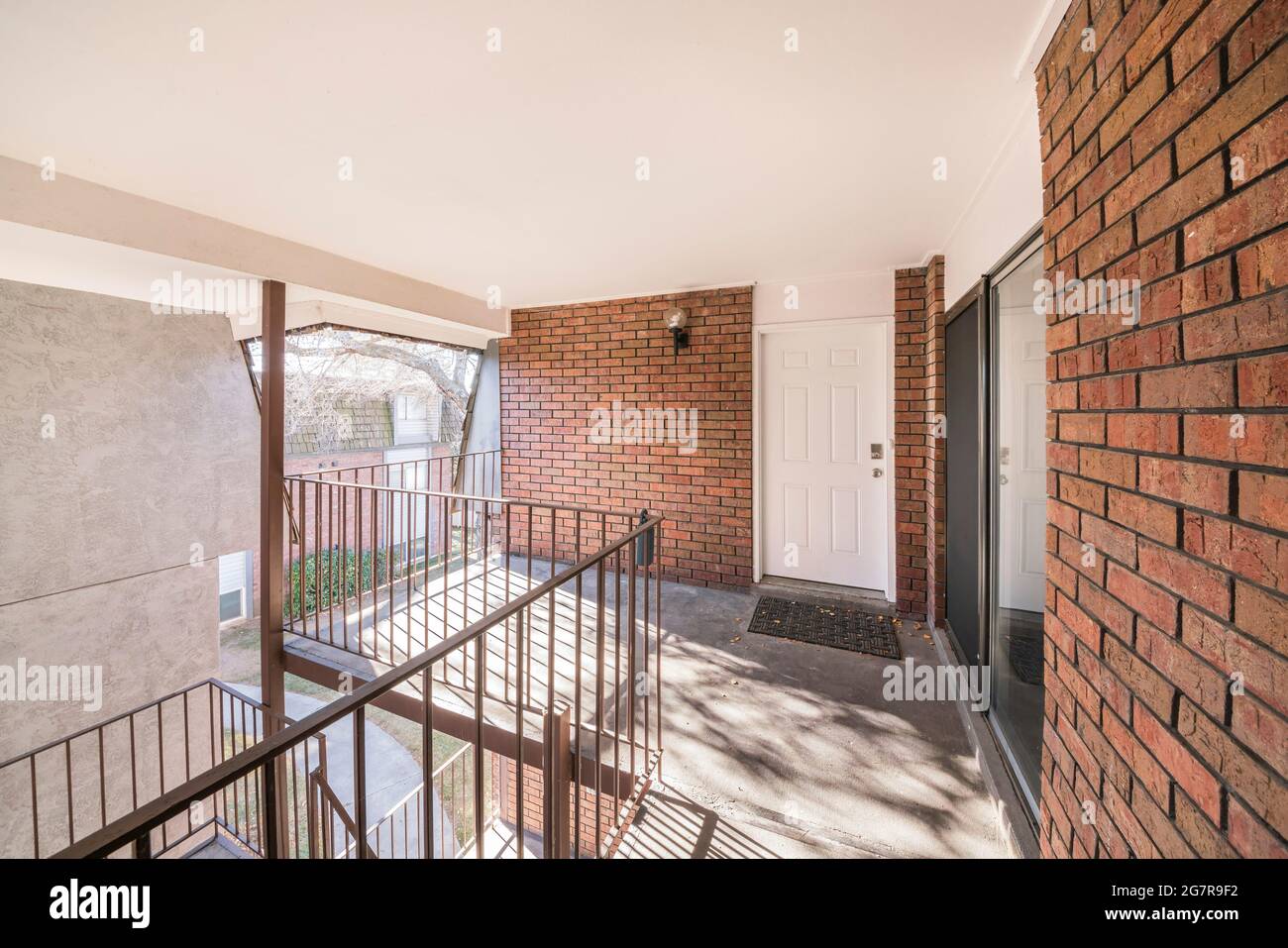 Front door of a second floor apartment with veranda Stock Photo - Alamy