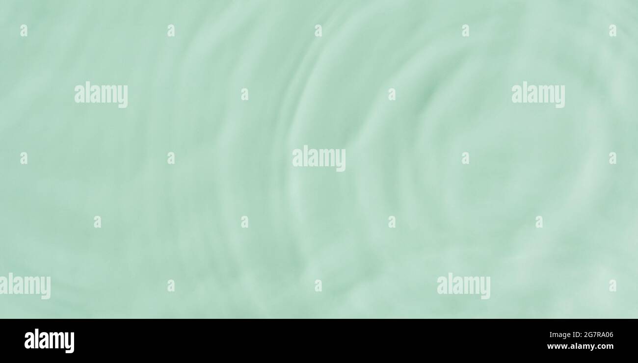 Aqua green water surface color background with ripples, circles and ...