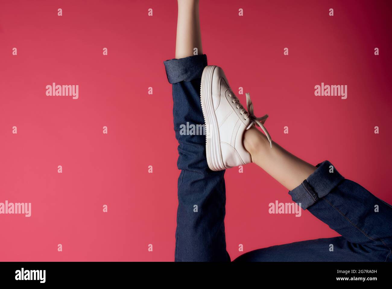 inverted female legs in white sneakers modern style isolated background ...