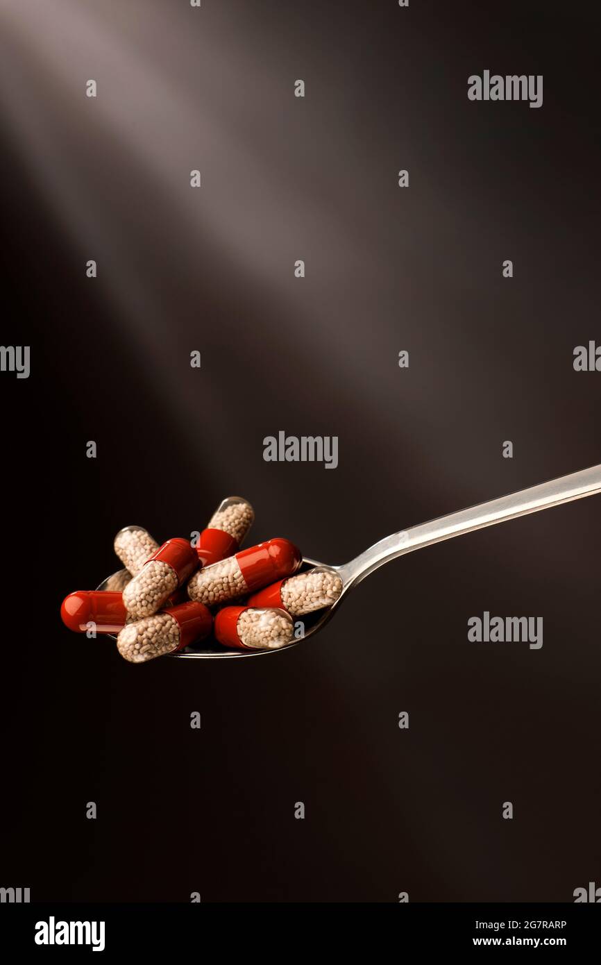 A spoon full of capsules that helps the pancreas to produce enzymes ...