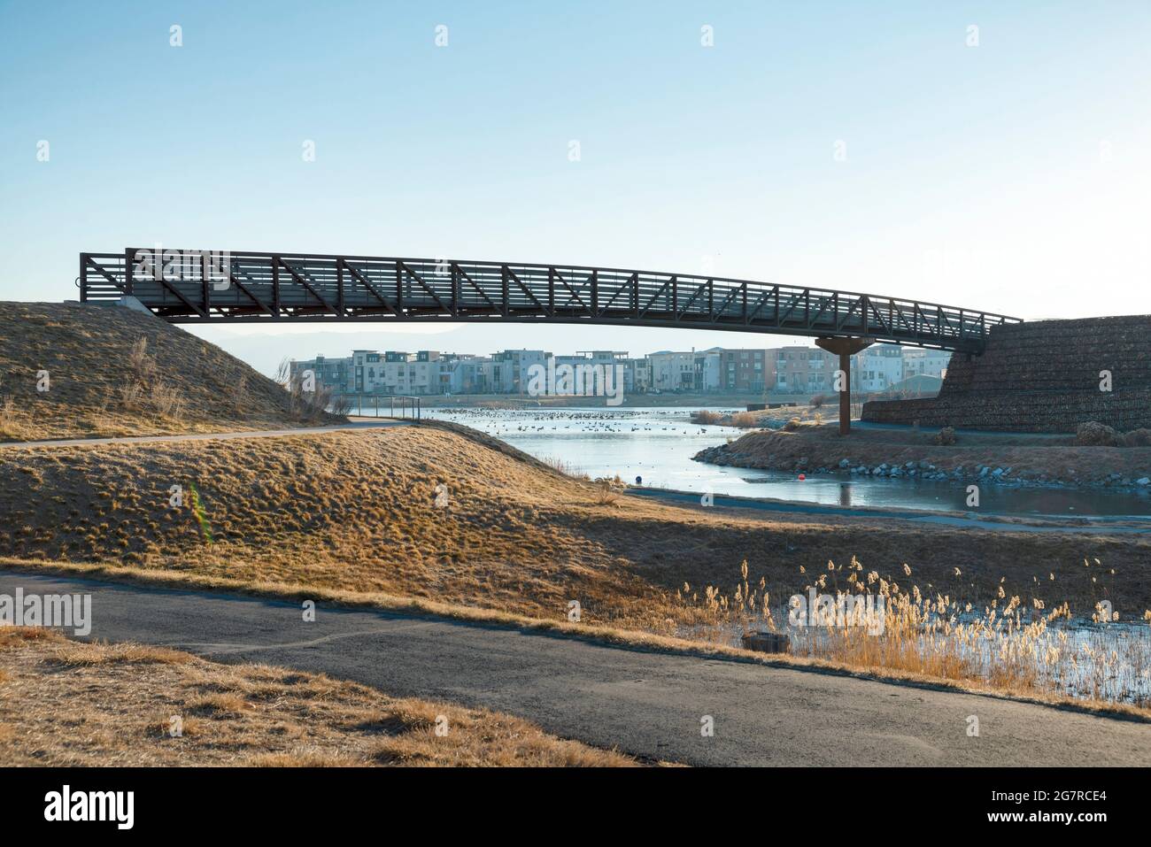 Pathway near the lake with a view of man-made footbridge on top Stock ...