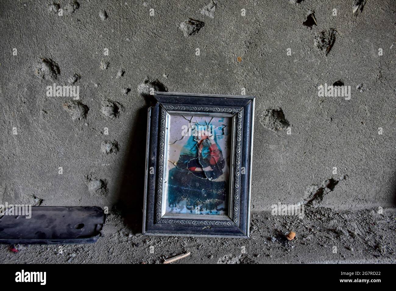 Srinagar, India. 16th July, 2021. A damaged photo frame is seen in ...