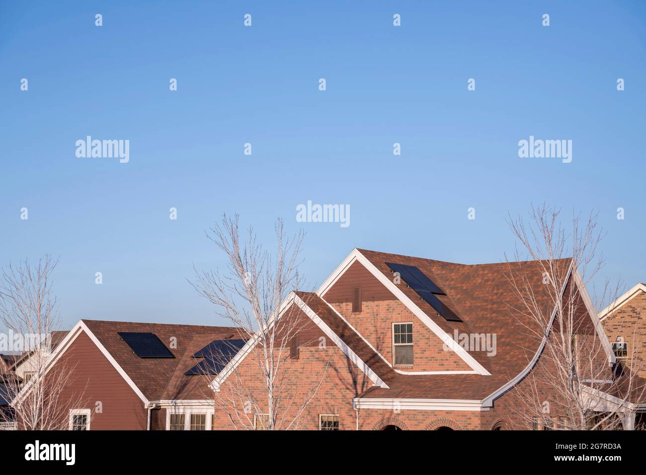 Large brownish red house exterior with stylish roof lines Stock Photo ...