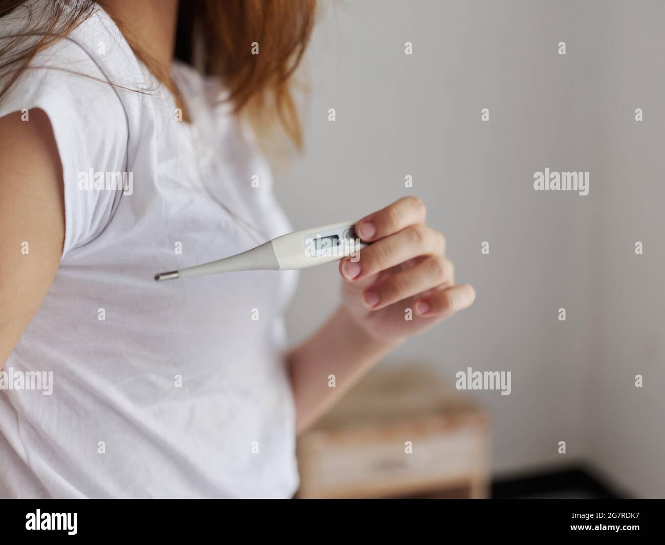 woman with armpit thermometer checking temperature Stock Photo - Alamy