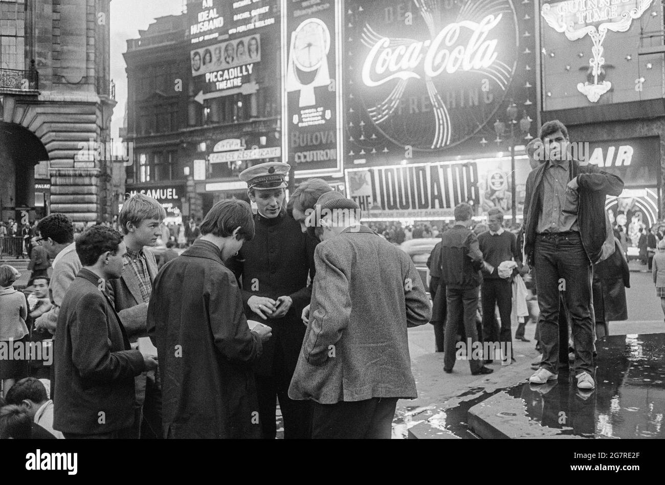 an officer from The Salvation Army (Regent Hall), London talks to young ...
