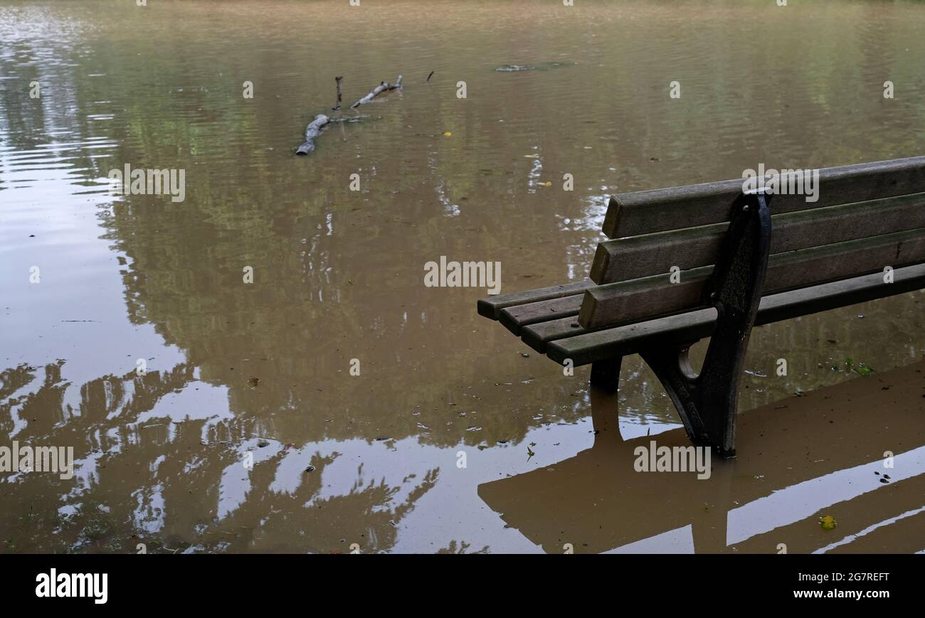 Extreme weather - bench in a flooded park in Düsseldorf, Germany Stock ...