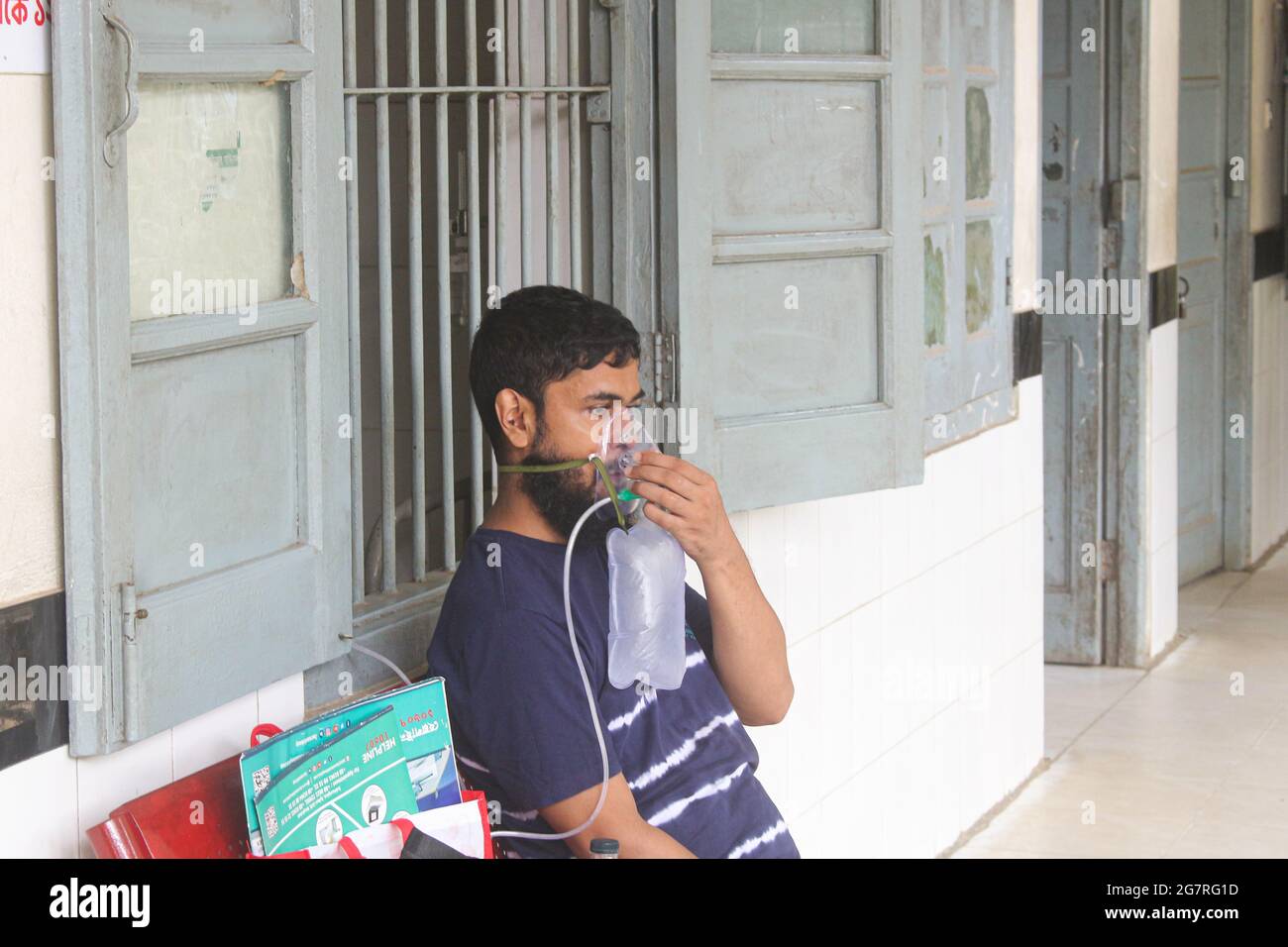 A Covid-19 patient taking Oxygen at the Covid -19 Isolation Center ...