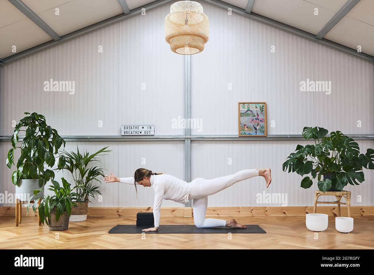 young Russian woman doing complex exercises and yoga stretching in a ...