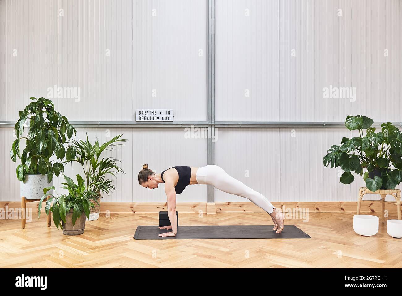 horizontal image with a yoga instructor doing pose and a large copy ...