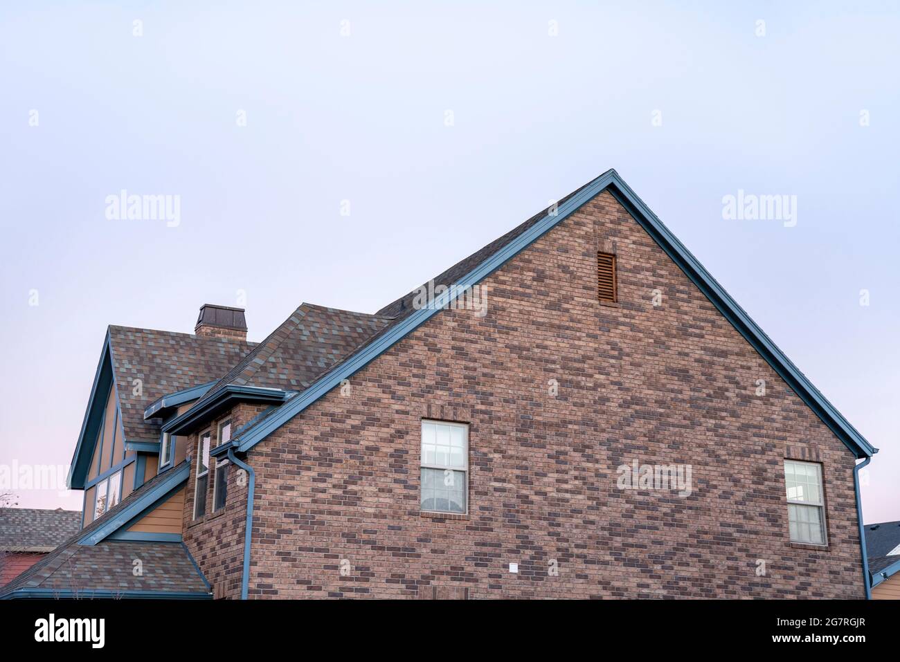 Side view of a two storey home with brown color tones Stock Photo - Alamy