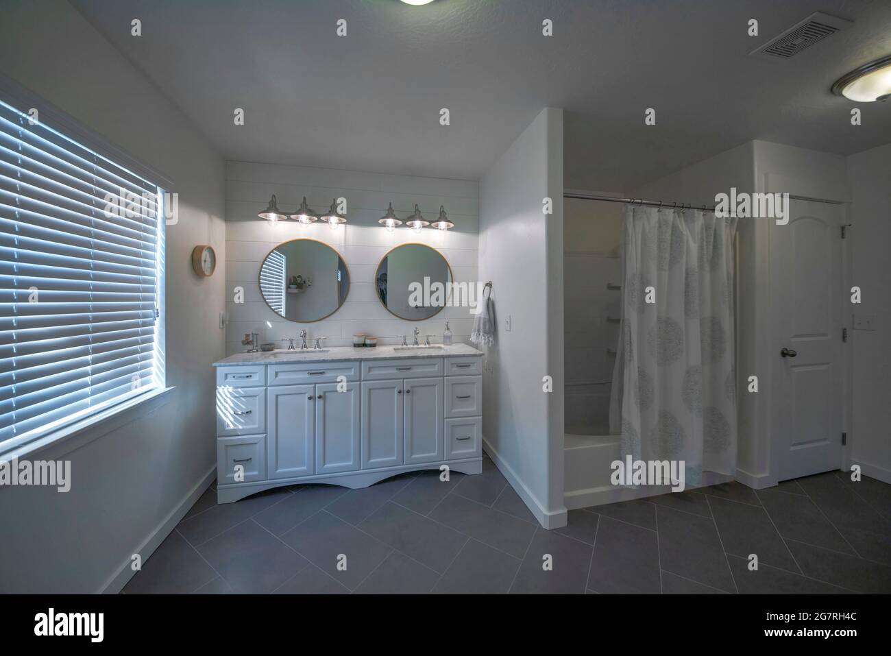 Large master bathroom interior with white walls and grau diagonal tile ...