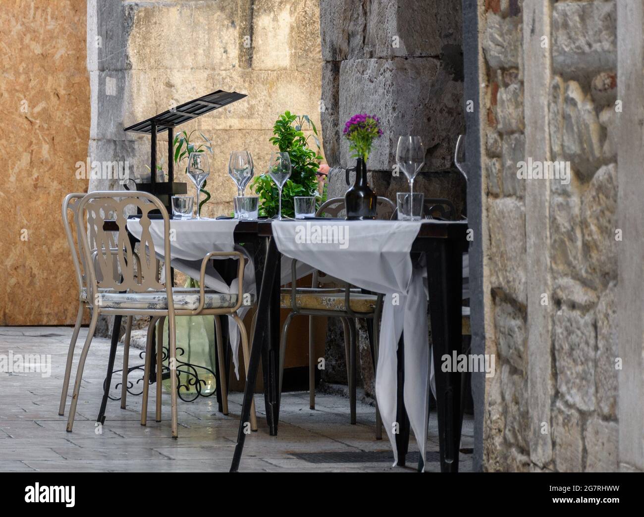 Empty tables in beautiful restaurant in narrow streets of old part of ...