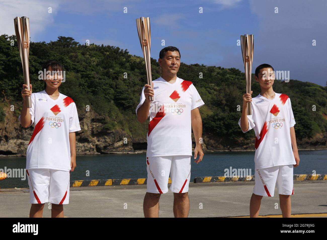 Local torchbearers pose during the Tokyo 2020 Olympic torch relay in ...