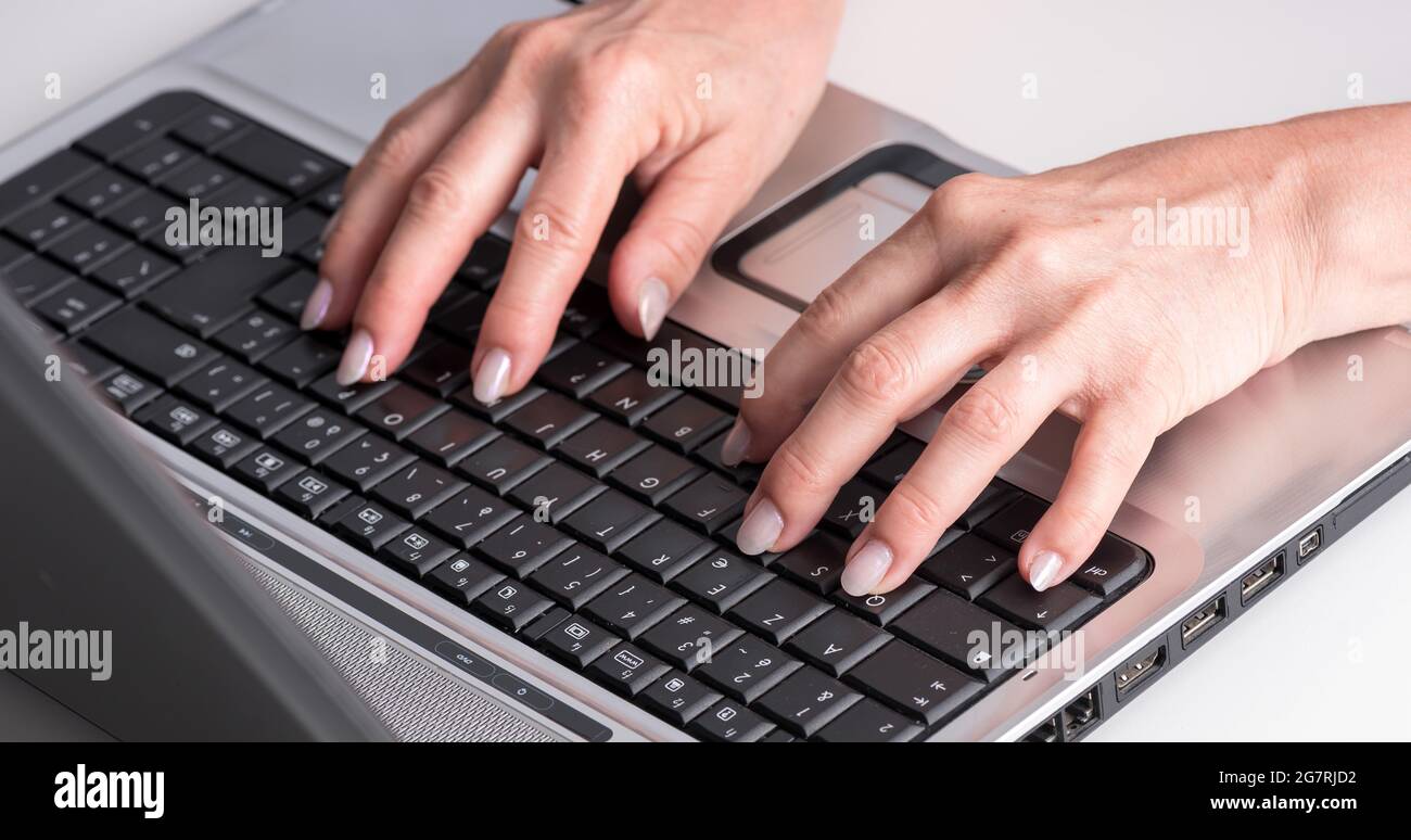 Female hands typing on a laptop keyboard Stock Photo - Alamy