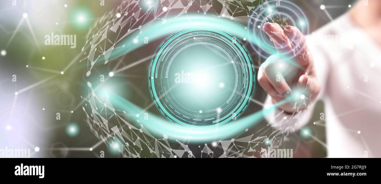 Woman touching a digital eye concept on a touch screen with her fingers ...