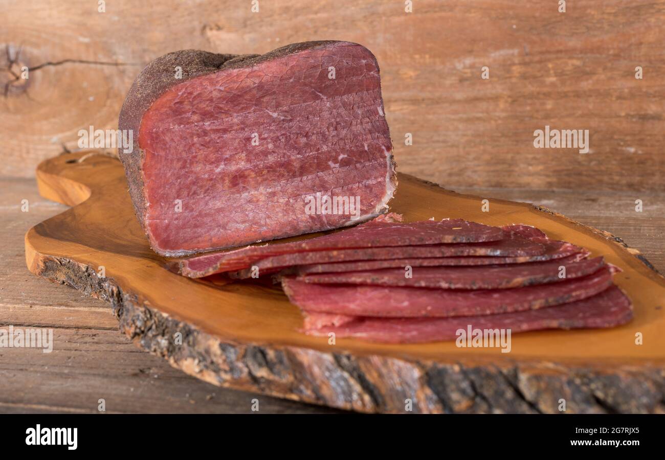 Dried meat on wooden background Stock Photo - Alamy