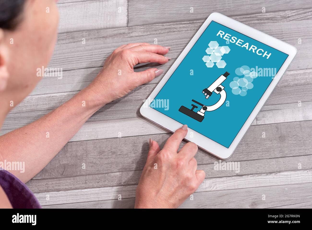 Woman using a tablet showing research concept Stock Photo - Alamy