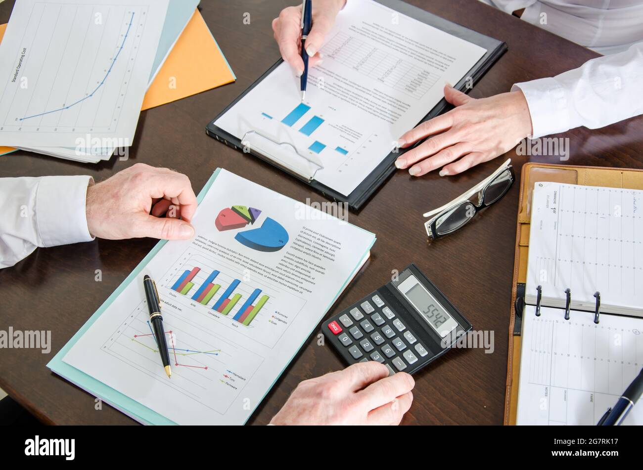 Two business people analyzing charts Stock Photo - Alamy