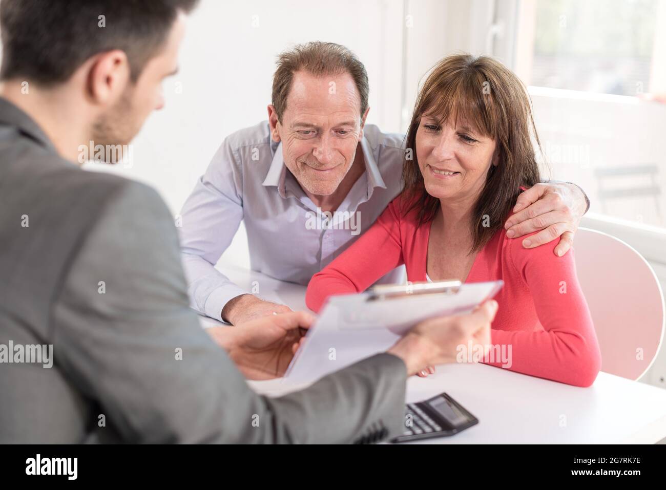 Senior couple meeting real estate agent for investment Stock Photo - Alamy