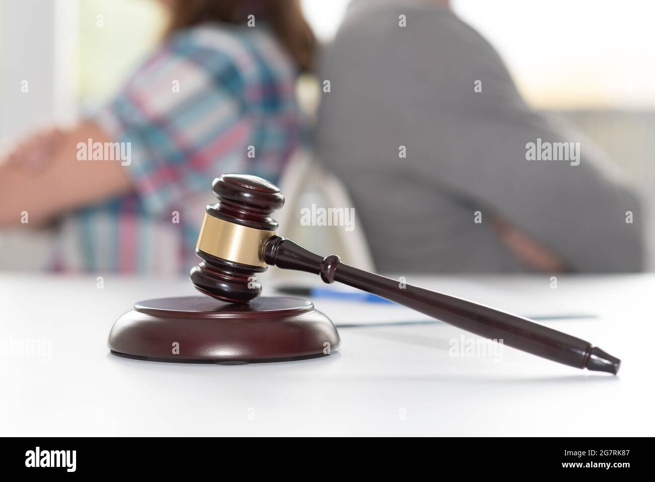 Divorce concept with judge gavel and couple sitting back to back in ...