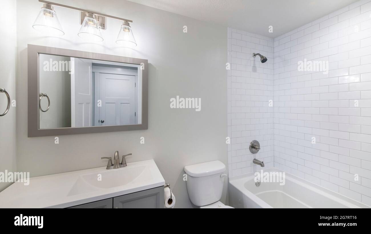 Pano Interior of a bathroom with vanity sink and shower tub combo with ...