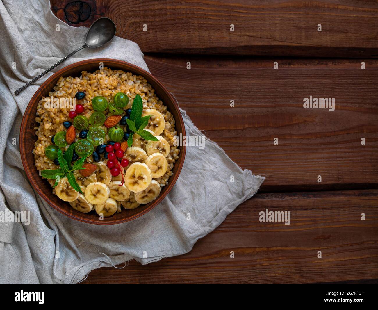 Wholegrain Oatmeal porridge bowl with fresh berries, fruits, nuts mint ...