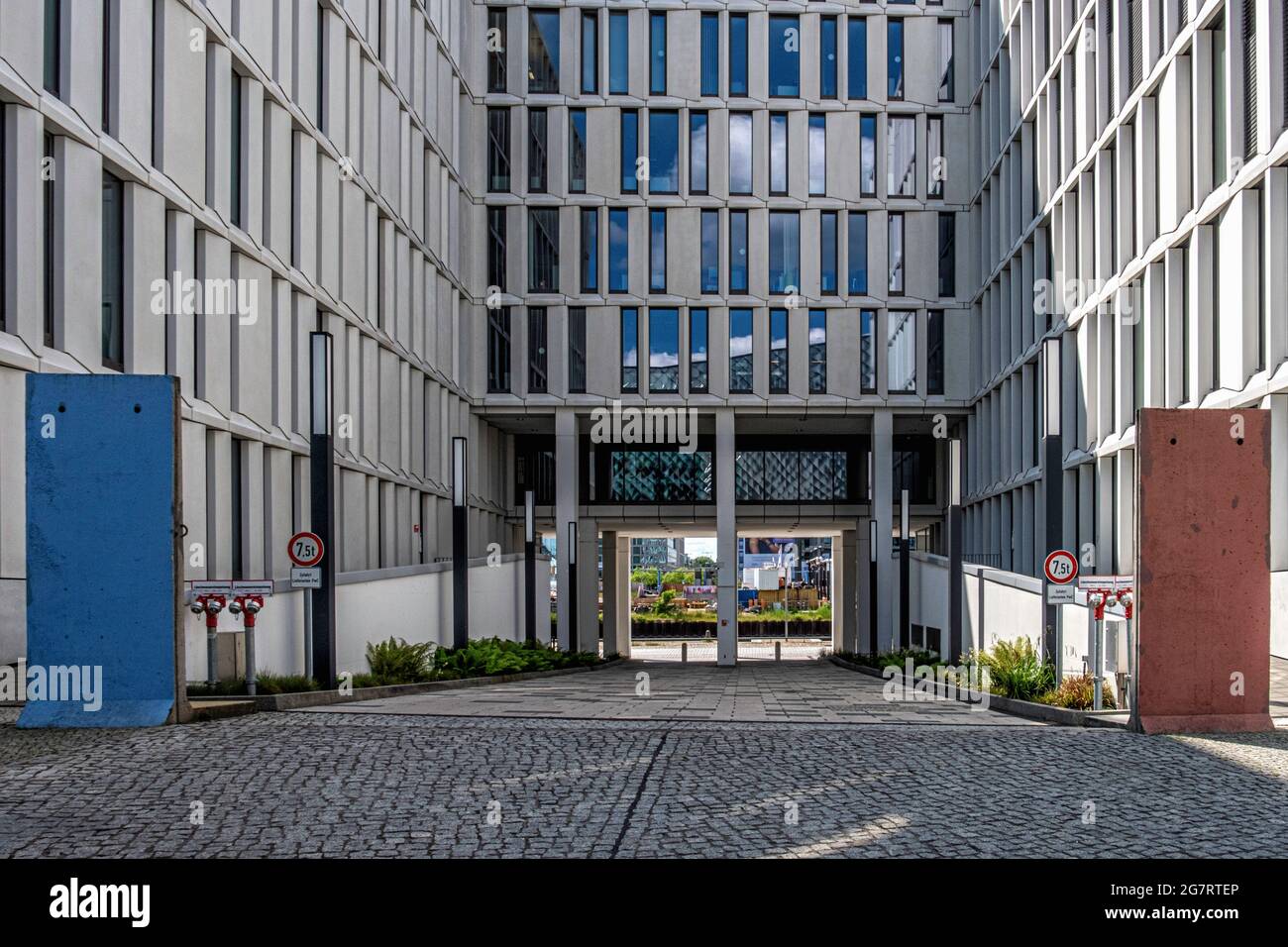 PricewaterhouseCoopers Modern building. Berlin wall pieces and cobble ...